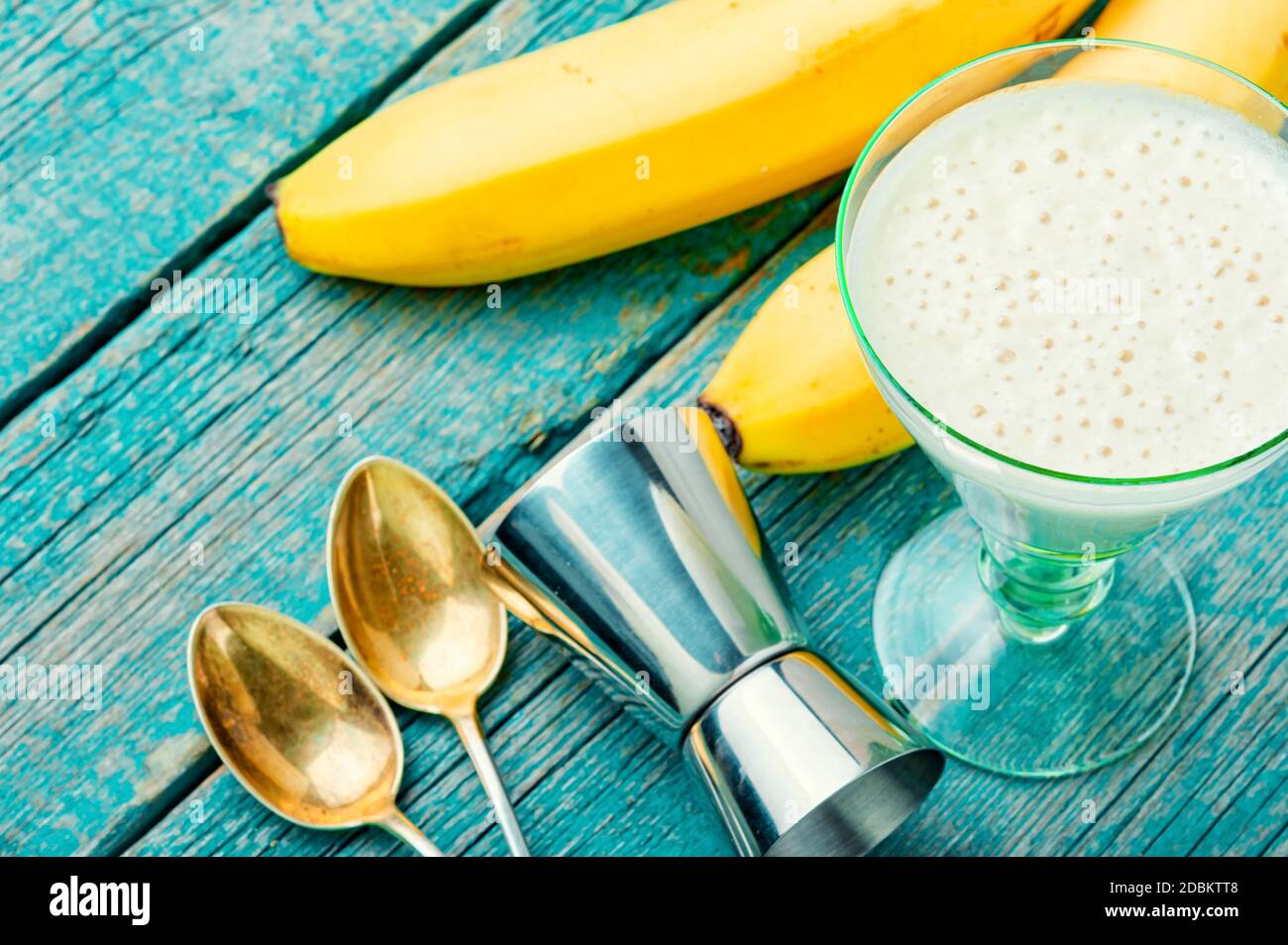 Homemade ripe banana liquor on a wooden background Stock Photo - Alamy