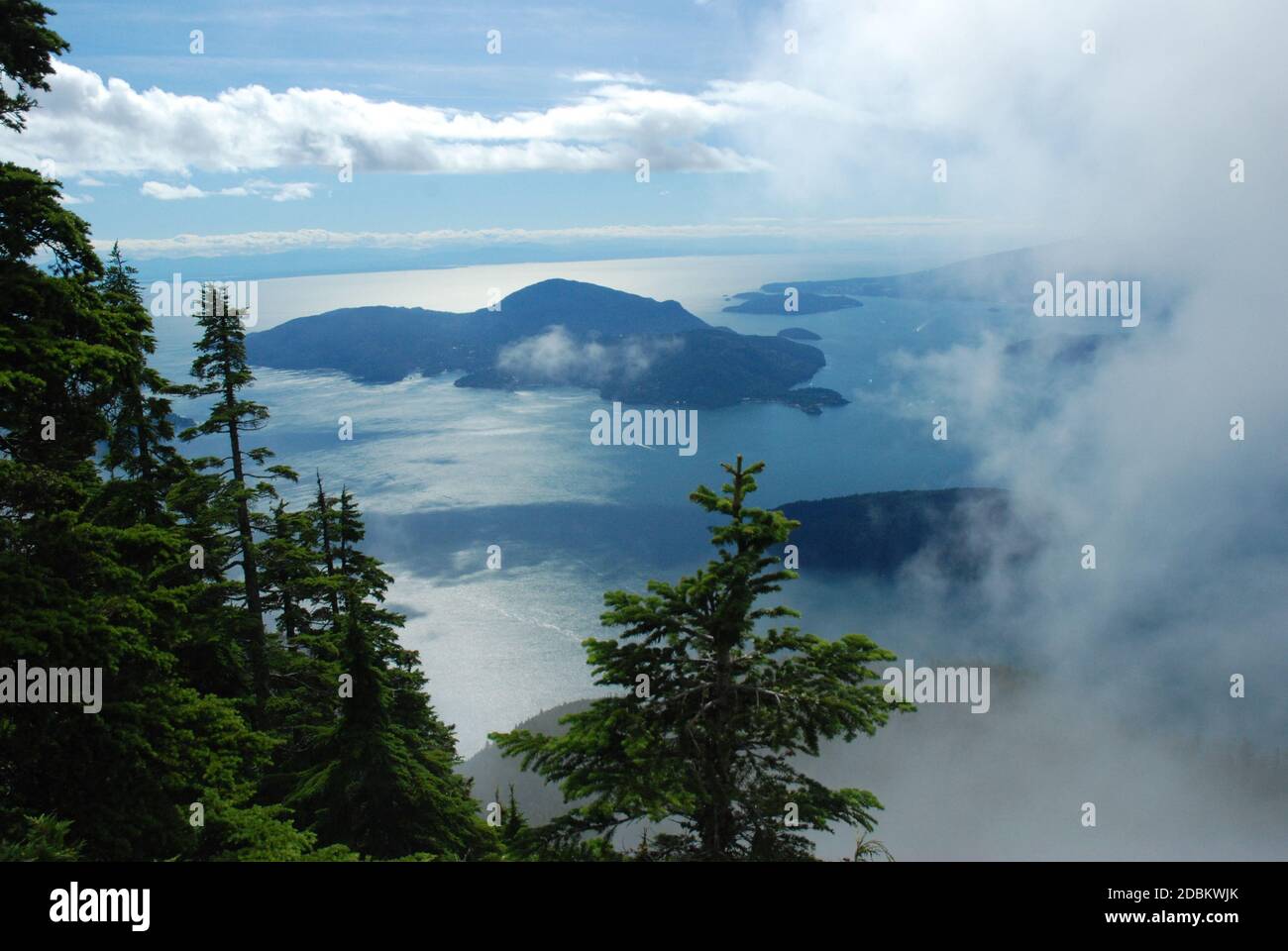 island appearing behind clouds - view from the top Stock Photo - Alamy
