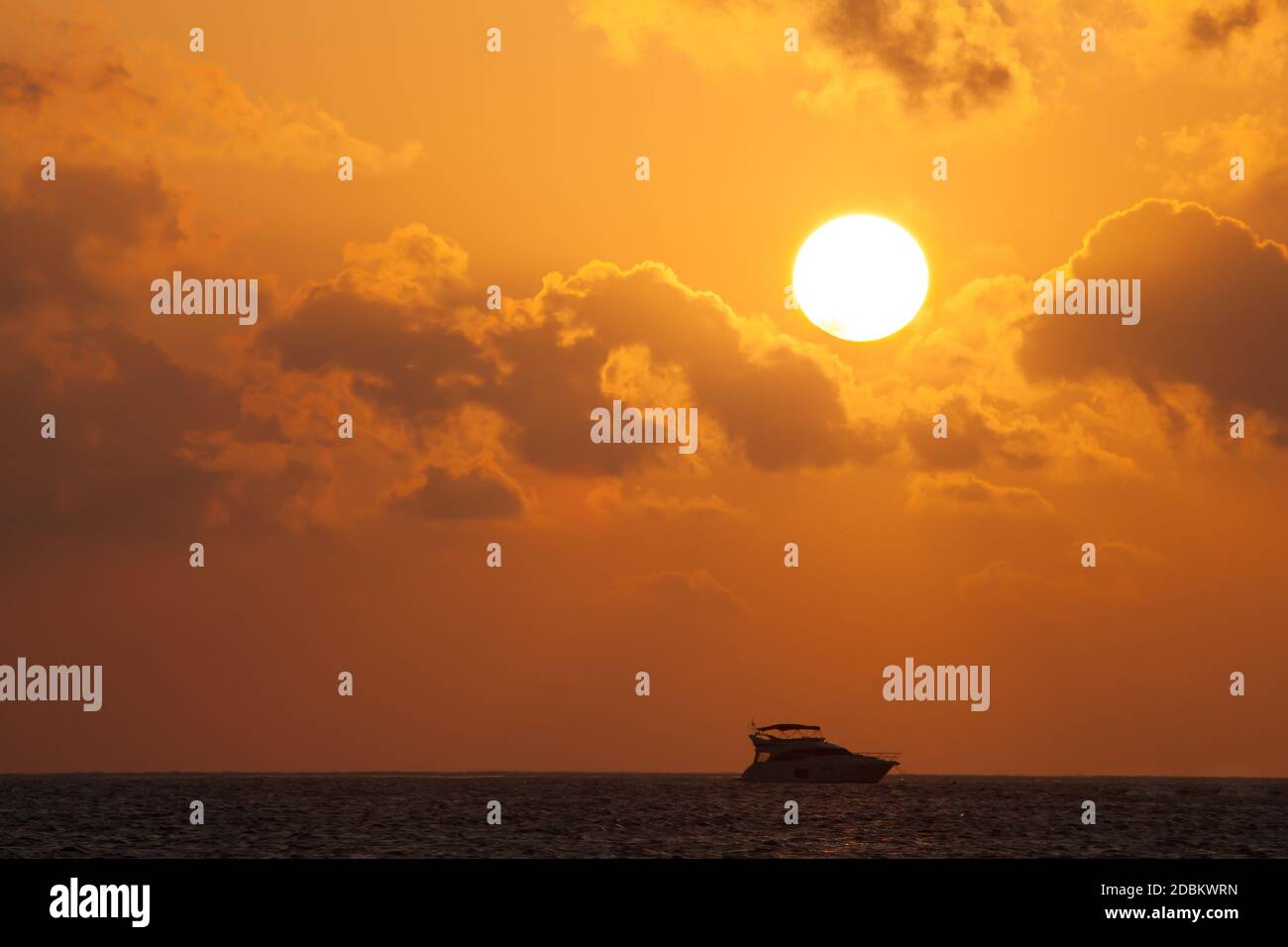 Sunset with a view to the ocean with boats Stock Photo - Alamy