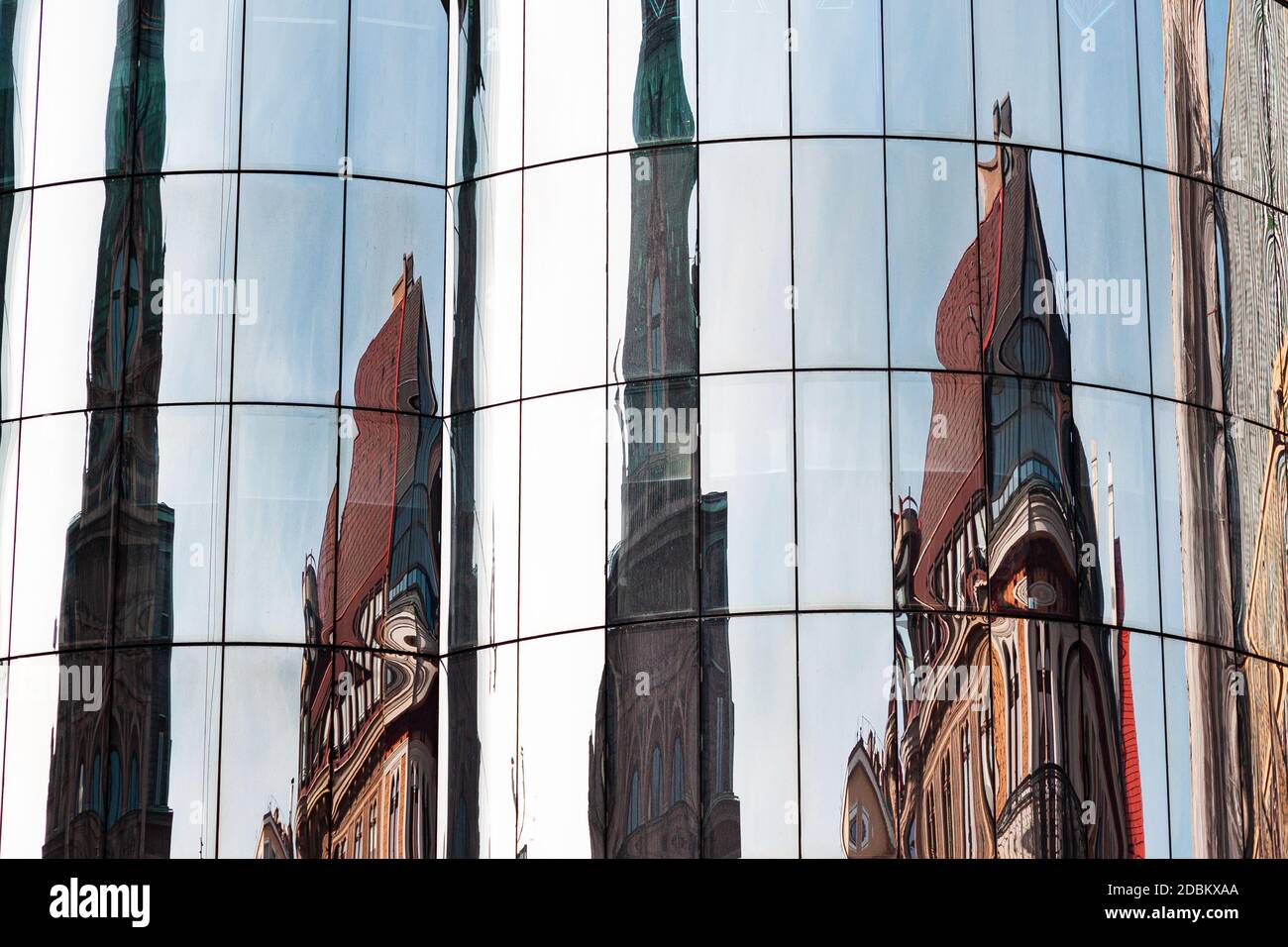 Reflection of an old church in the windows of a modern building Stock ...