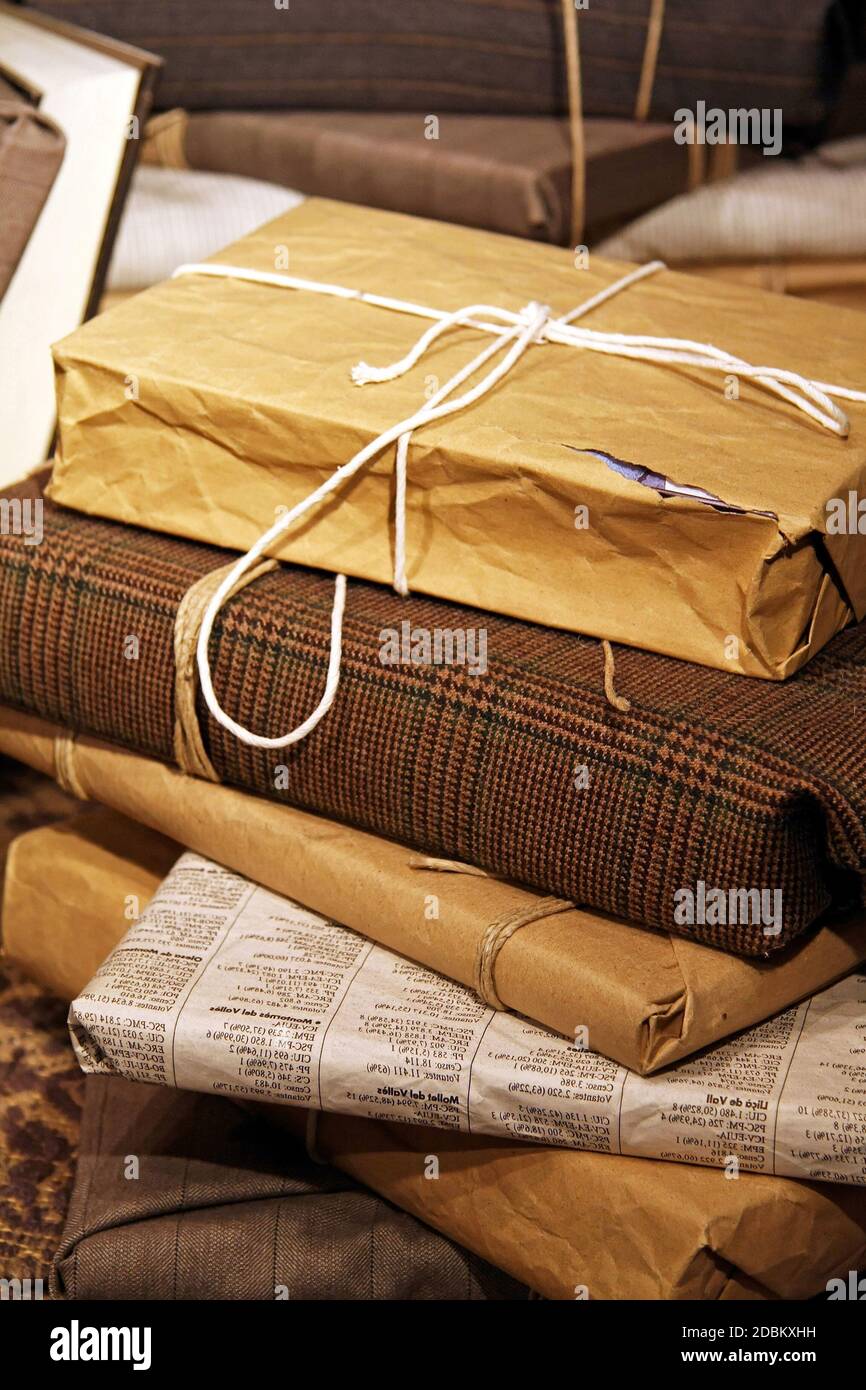 Big stack of gifts wrapped in recycled paper Stock Photo - Alamy