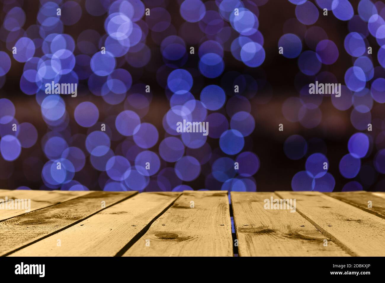 Wooden desk over blurred interior scene desk Stock Photo - Alamy