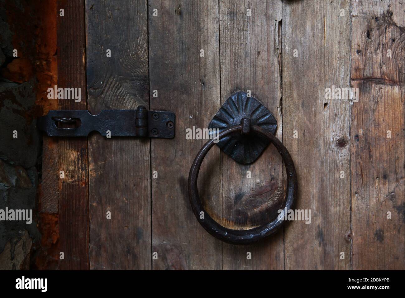 Vintage iron handle and lock loop on wooden door .Black wrought iron ...