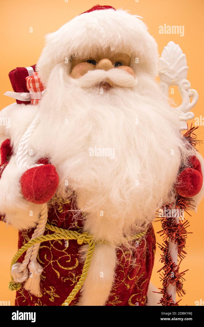Ceramic statuette of Santa Claus in a red coat holding a staff isolated ...