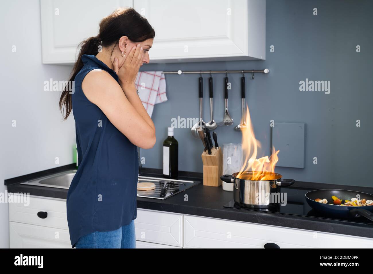 Fire In Kitchen. Pot Burning While Cooking At Home Stock Photo - Alamy