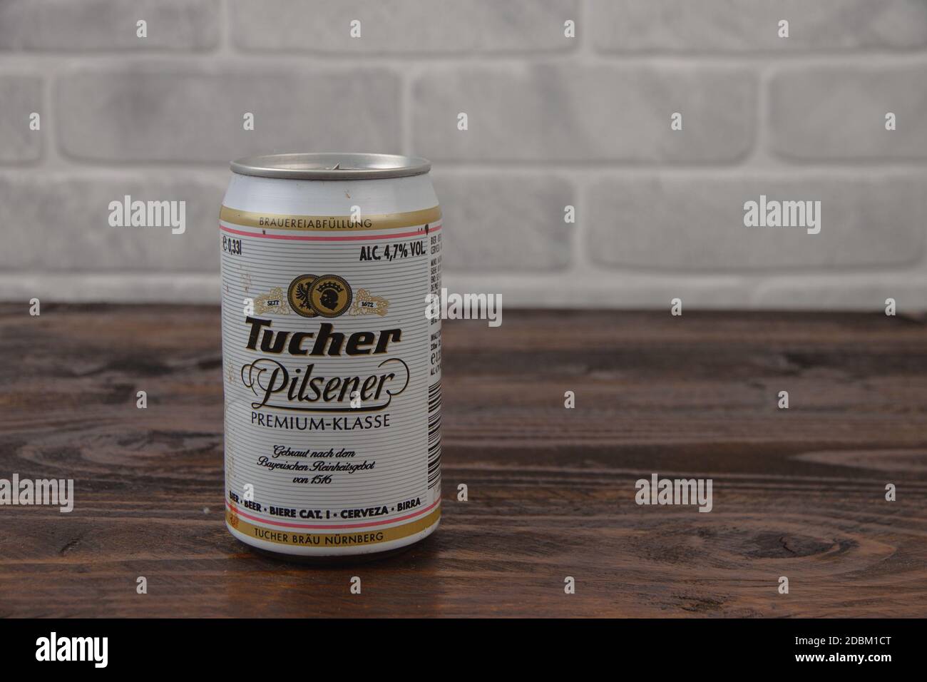 An old aluminium can of Tucher Pilsener beer against the brick wall ...