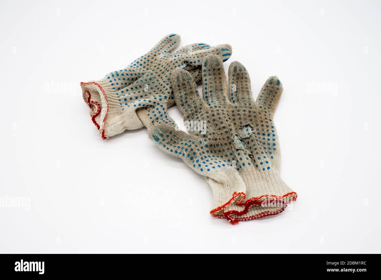 Worn, torn gloves on a white background Stock Photo - Alamy