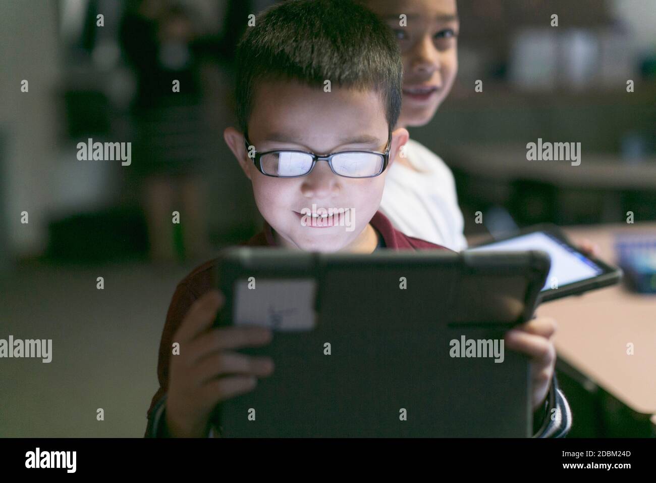 Two smart little boys enjoy practicing their lessons on their ...