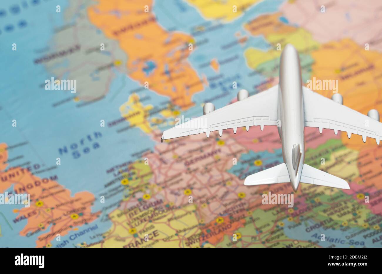 Toy of a plane flying over the Europe map Stock Photo - Alamy