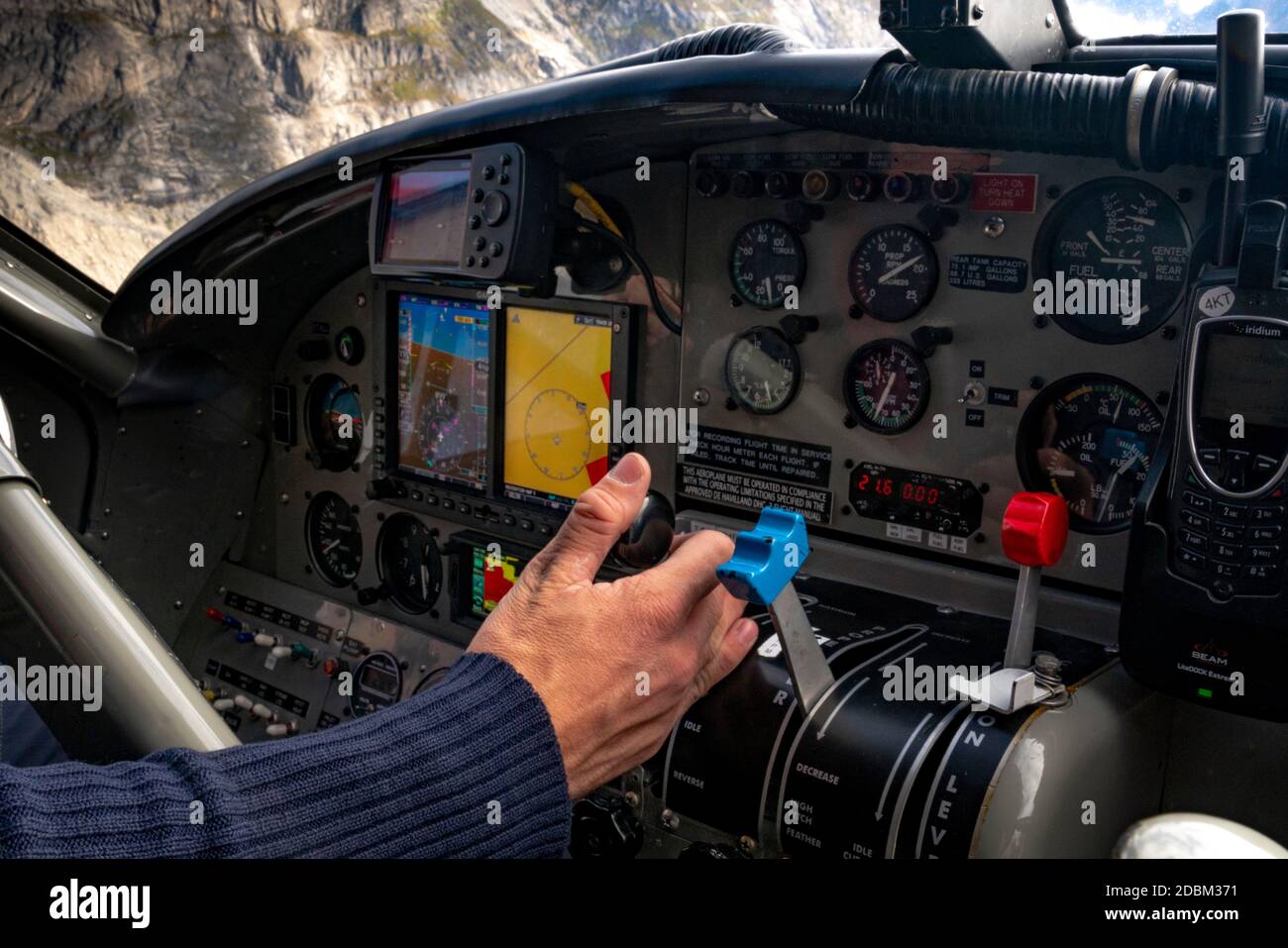 Hand of man piloting airplane over Denali National Park, Alaska, USA ...