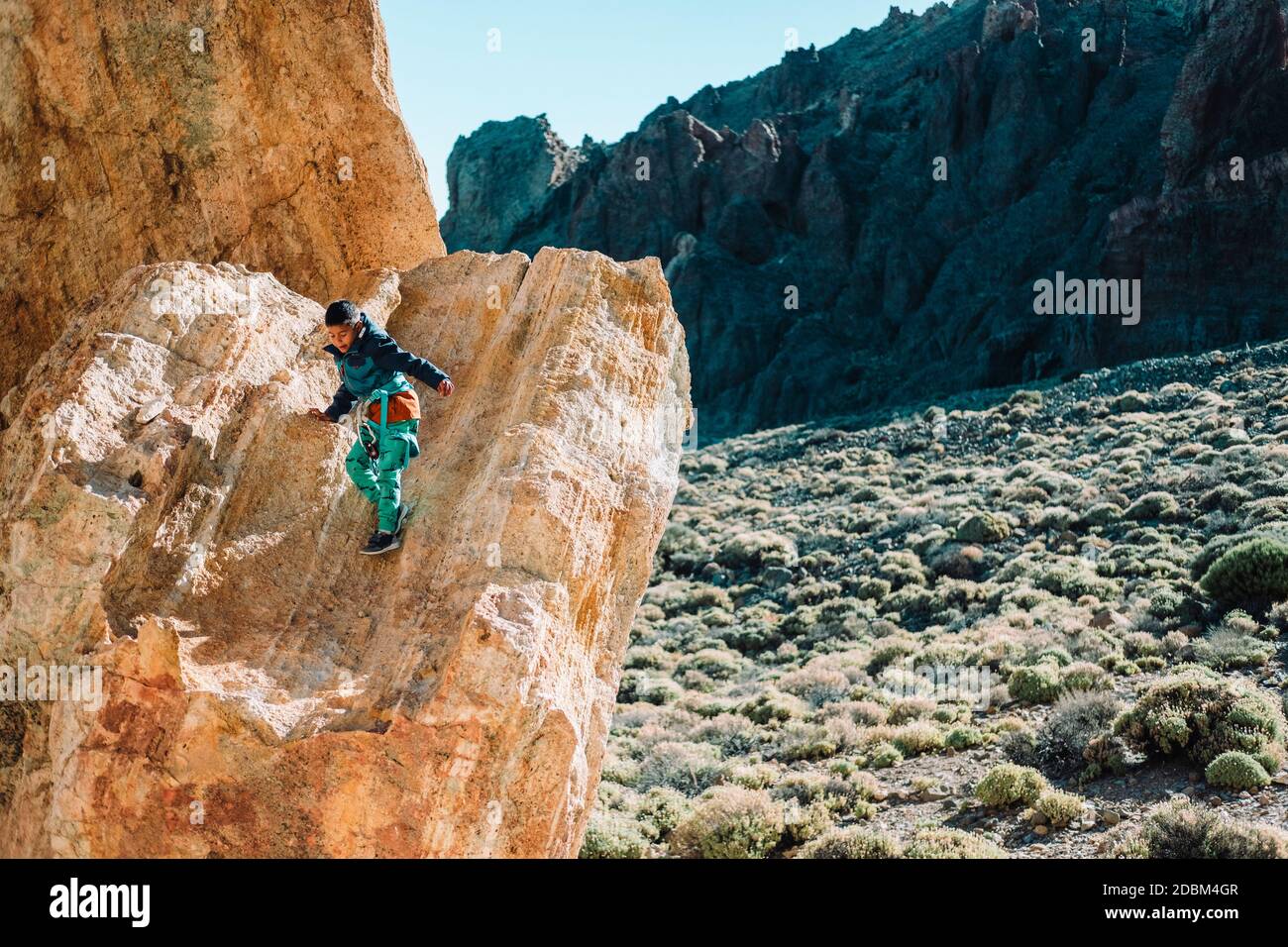 Boy walking on rock formation, Tenerife, Canary Islands, Spain Stock ...
