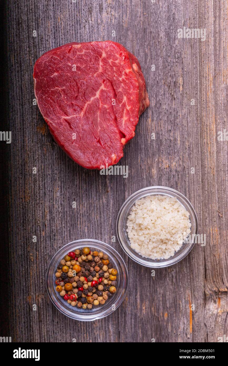 overview of a raw steak on wood Stock Photo - Alamy