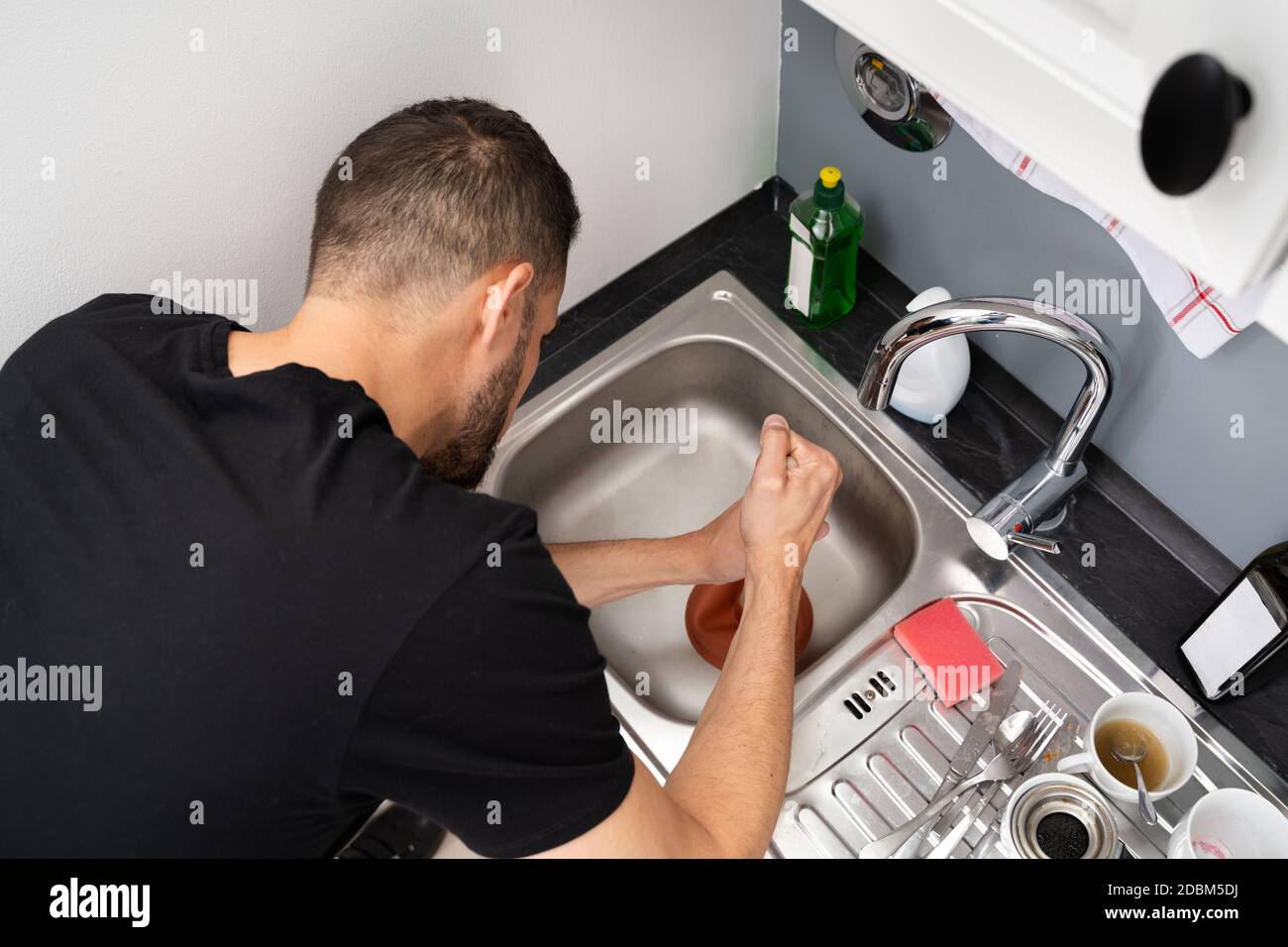 Cleaning Blocked Drain Clog In Kitchen Sink Using Plunger Stock Photo ...