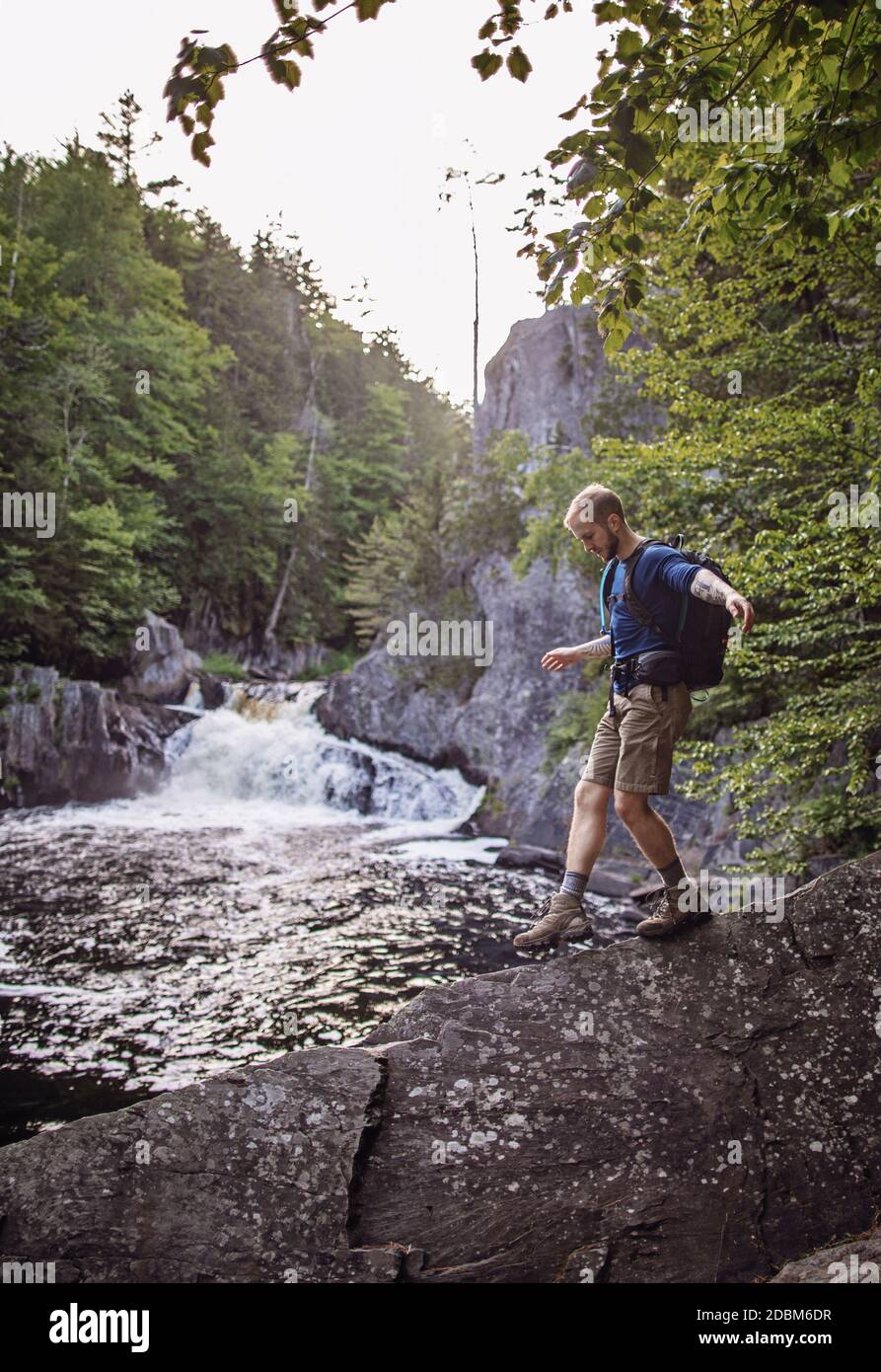 Man walking across rocks hi-res stock photography and images - Alamy