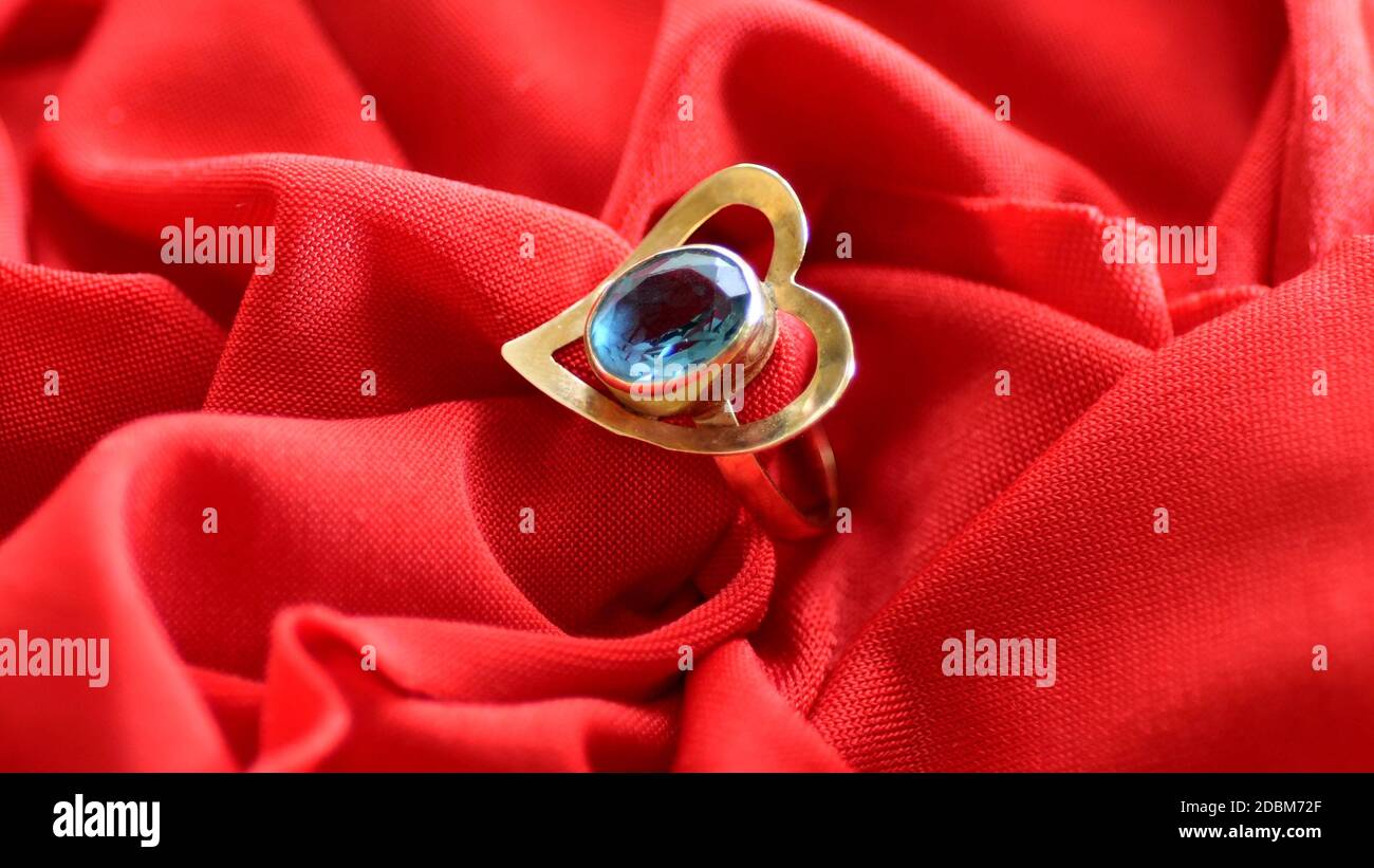 Diamond Ring On Red Satin Stock Photo - Alamy