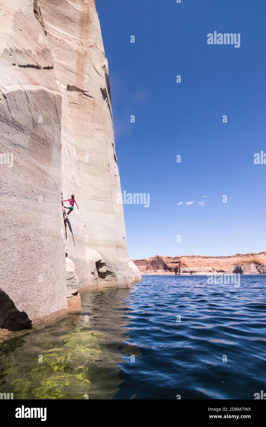 Woman rock climbing up cliff, Lake Powell, Utah, USA Stock Photo - Alamy