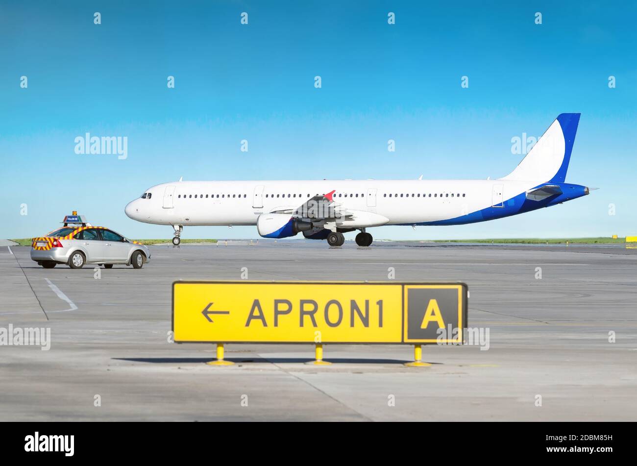 Aircraft at the airport after landing and the airport service car with ...