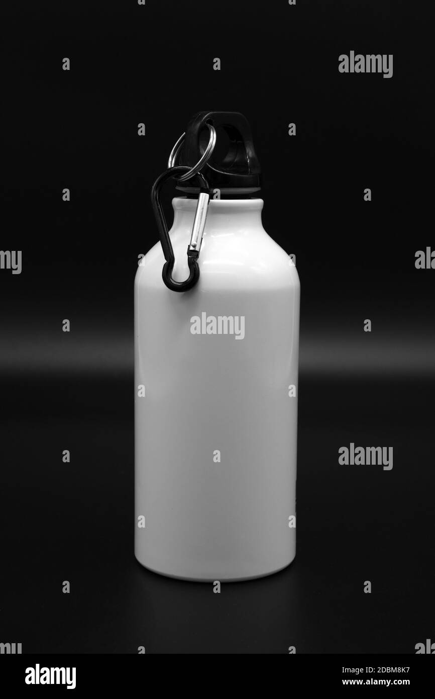 White travel flask with hook isolated on black background for attaching ...