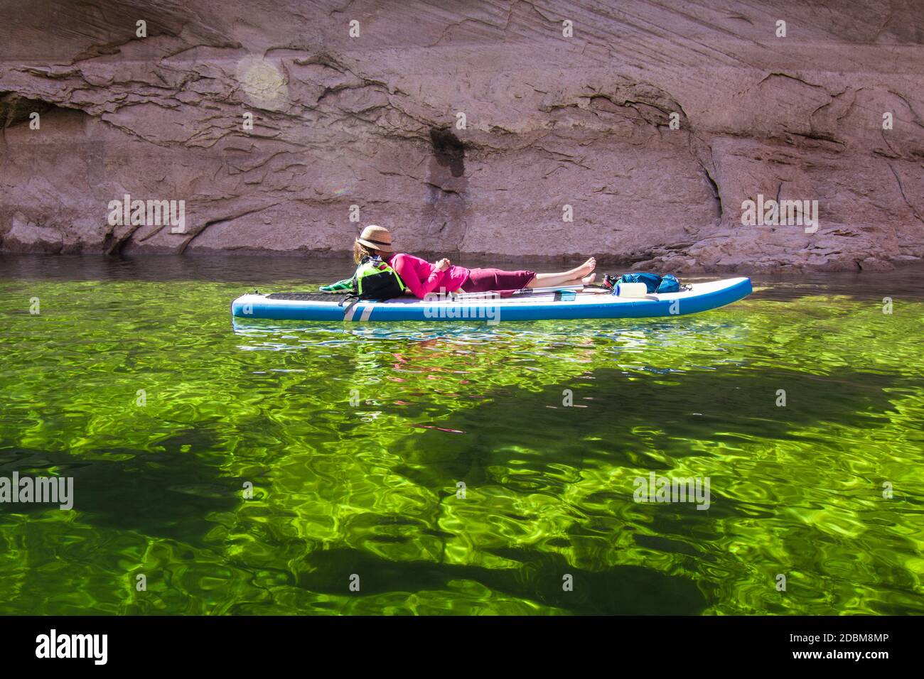 Woman relaxing on paddle board, Lake Powell, Utah, USA Stock Photo - Alamy