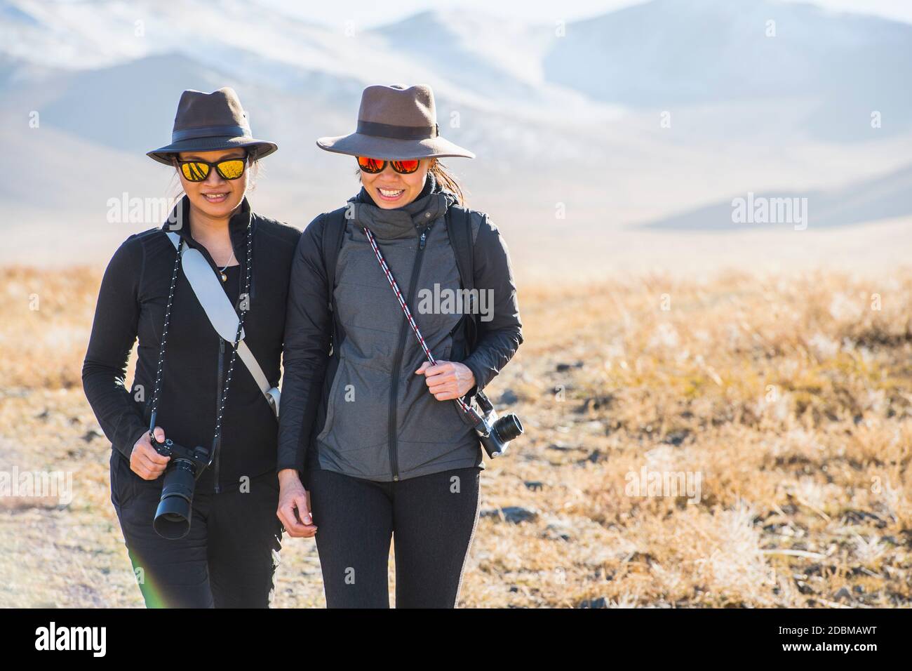 Two women hiking with cameras, Olgiy, Bayan-Olgiy, Mongolia Stock Photo ...
