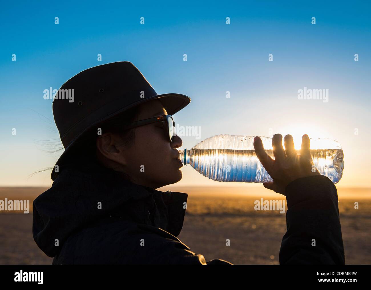 Silhouette woman holding water bottle hi-res stock photography and ...