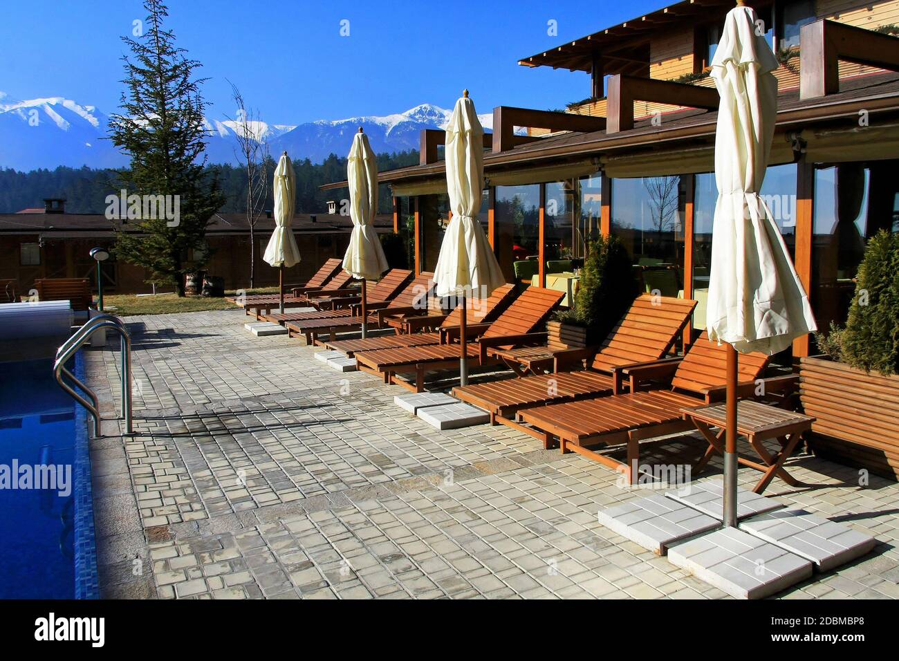 Resort terrace with swimming pool and sunny lounges Stock Photo - Alamy