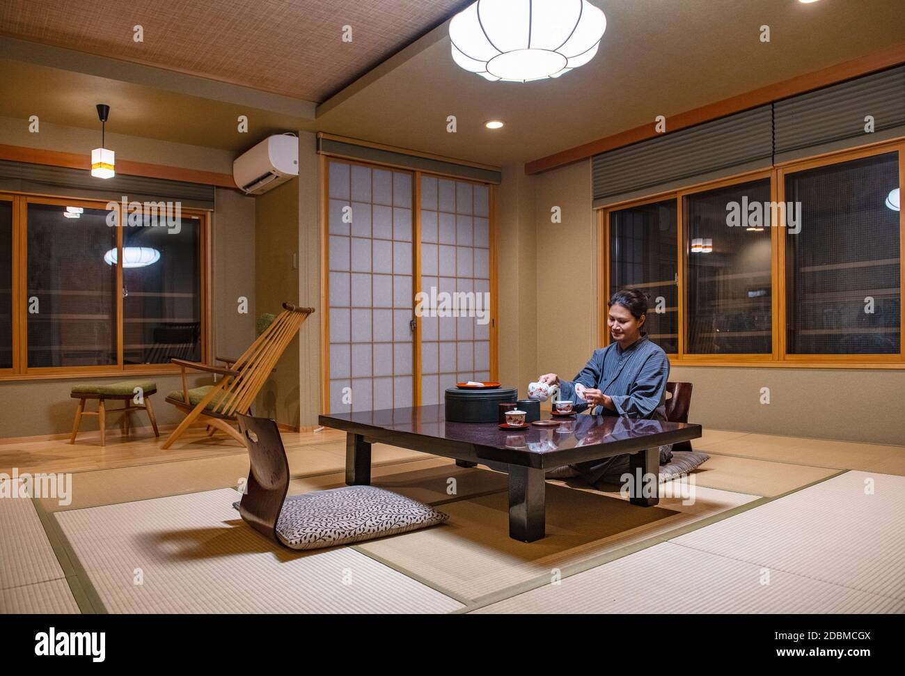 Women poring tea in traditional Japanese home Stock Photo - Alamy