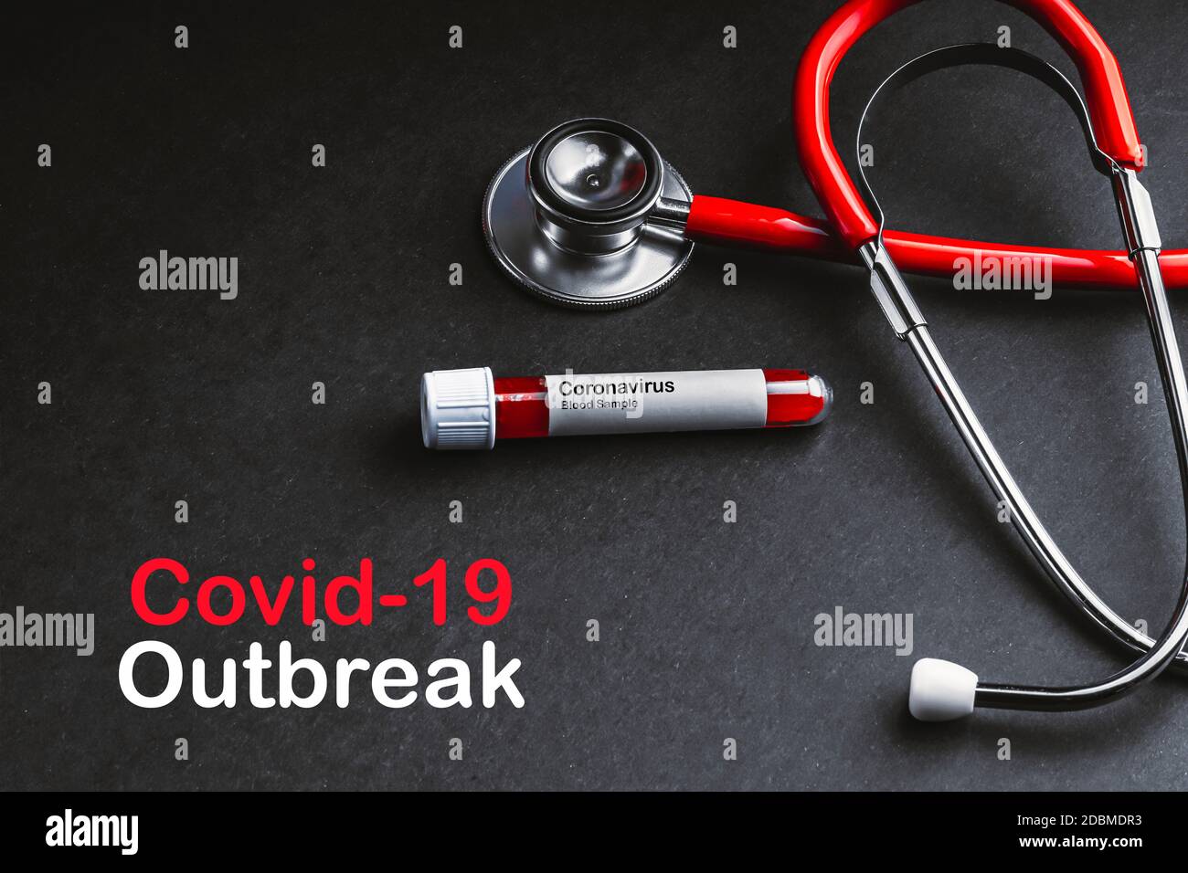COVID-19 OUTBREAK text with stethoscope and blood sample vacuum tube on ...