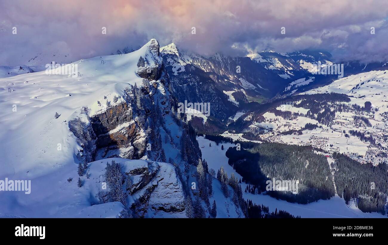 Flight over snow-capped mountains in the Swiss Alps on a winter's day ...