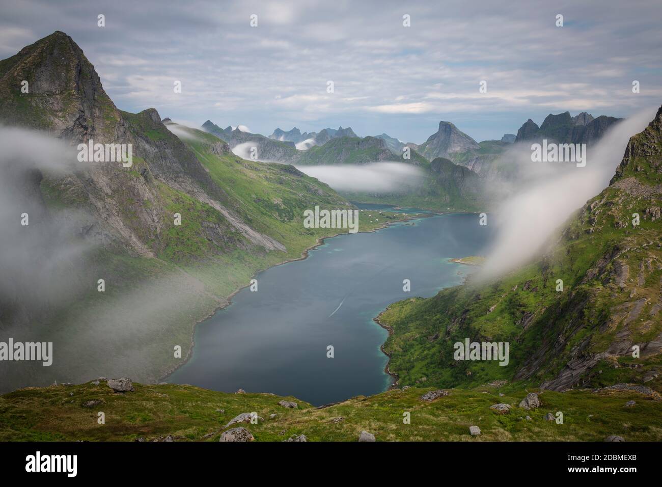 Fog forms amongs the mountains surrounding Forsfjord, Moskenesøy ...