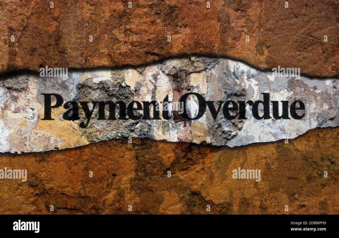 Payment overdue text on wall Stock Photo - Alamy