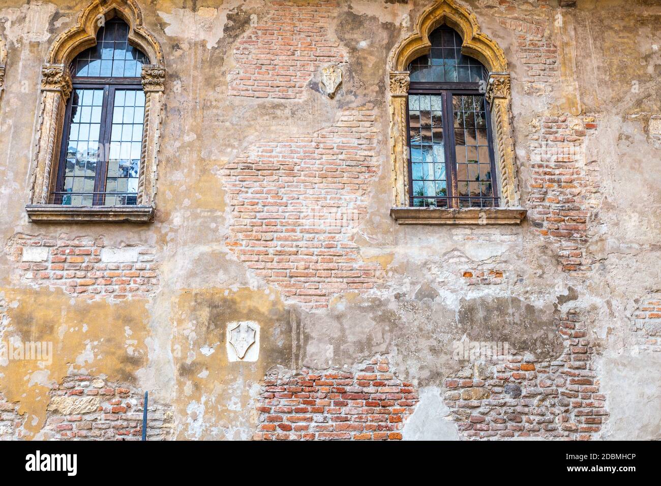 windows in the facades of ancient medieval Venetian houses Stock Photo ...