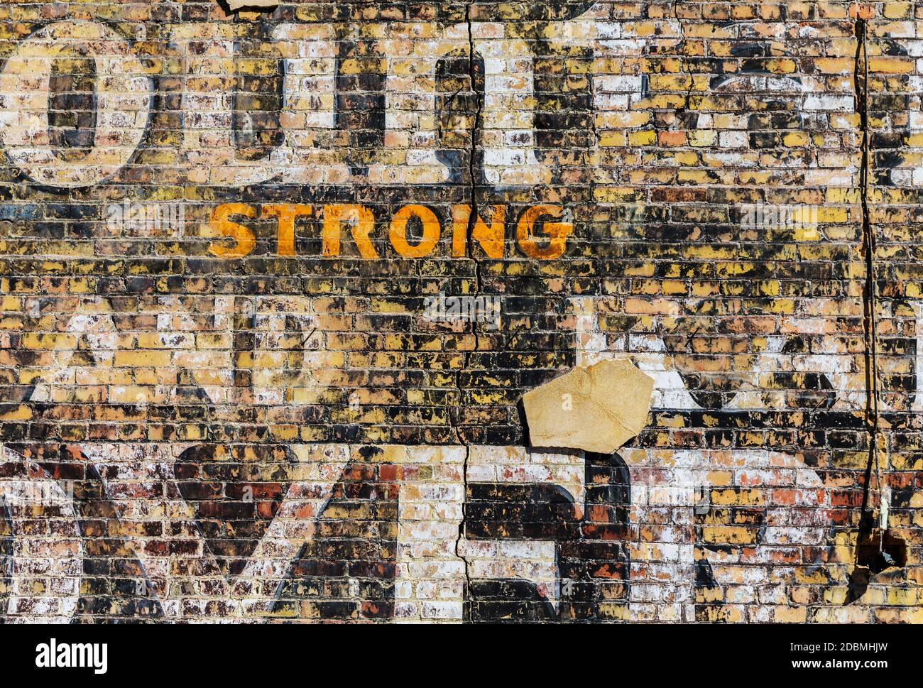 Writing on the side of an old brick building Stock Photo - Alamy