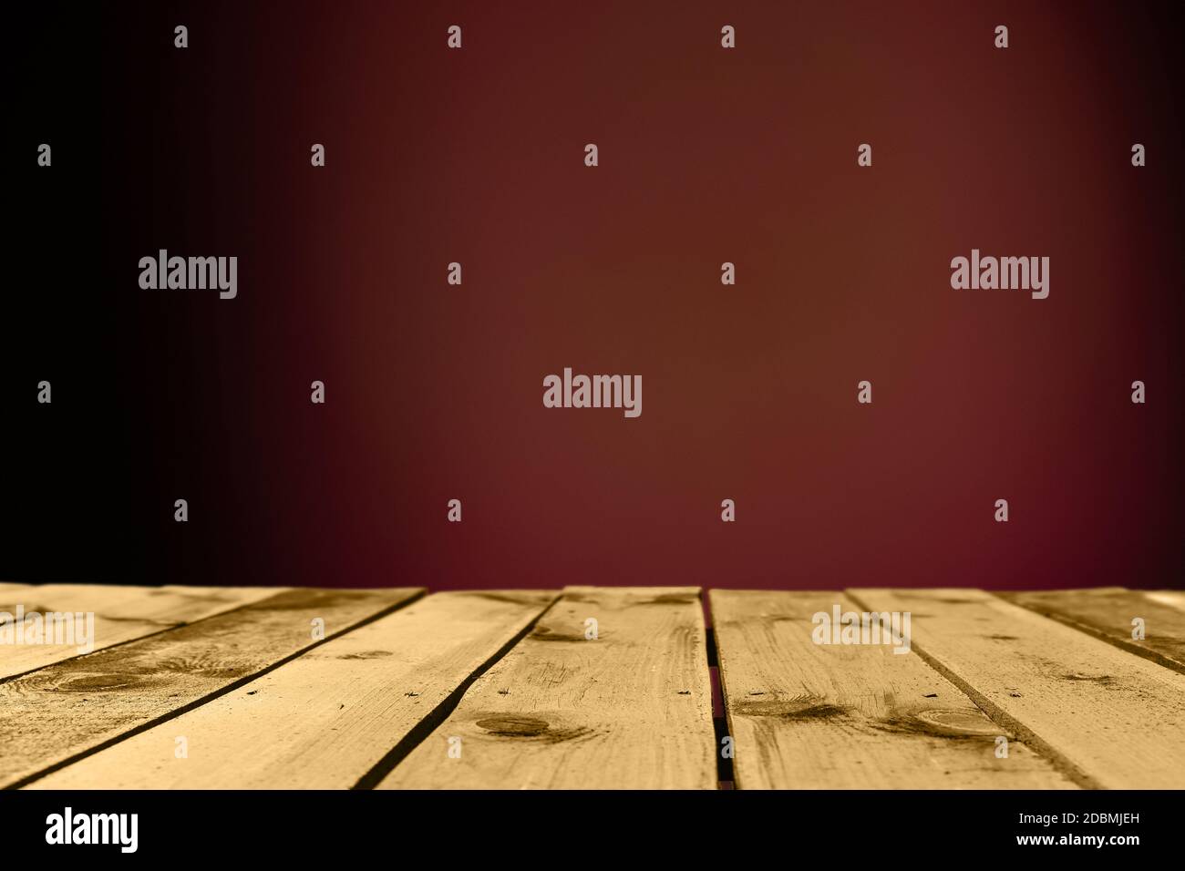 Wooden desk over blurred interior scene desk Stock Photo - Alamy