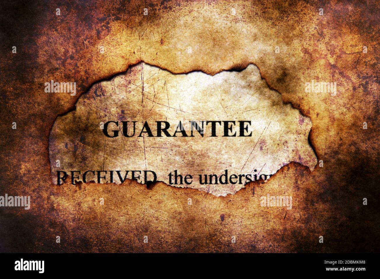 Guarantee text on paper hole grunge concept Stock Photo - Alamy