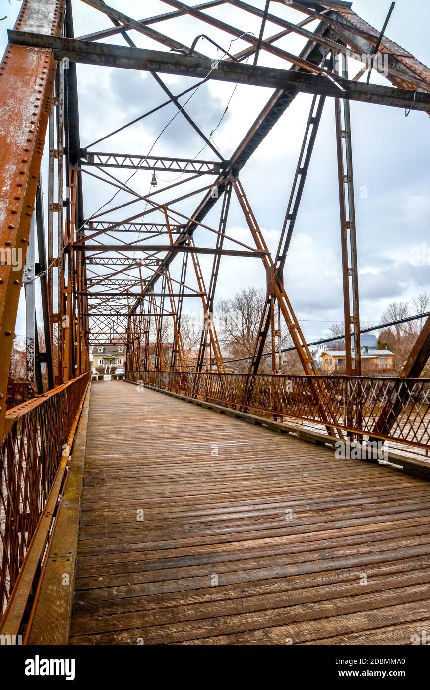 old bridge in rusty metal structure and wooden floor of Saint-Pie ...
