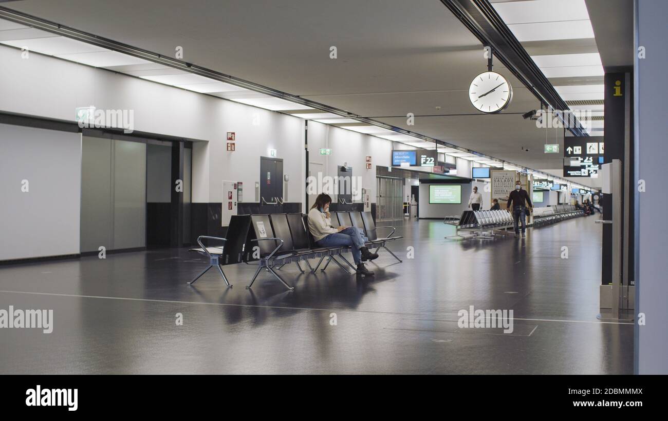 Woman waiting at arrival gates hi-res stock photography and images - Alamy