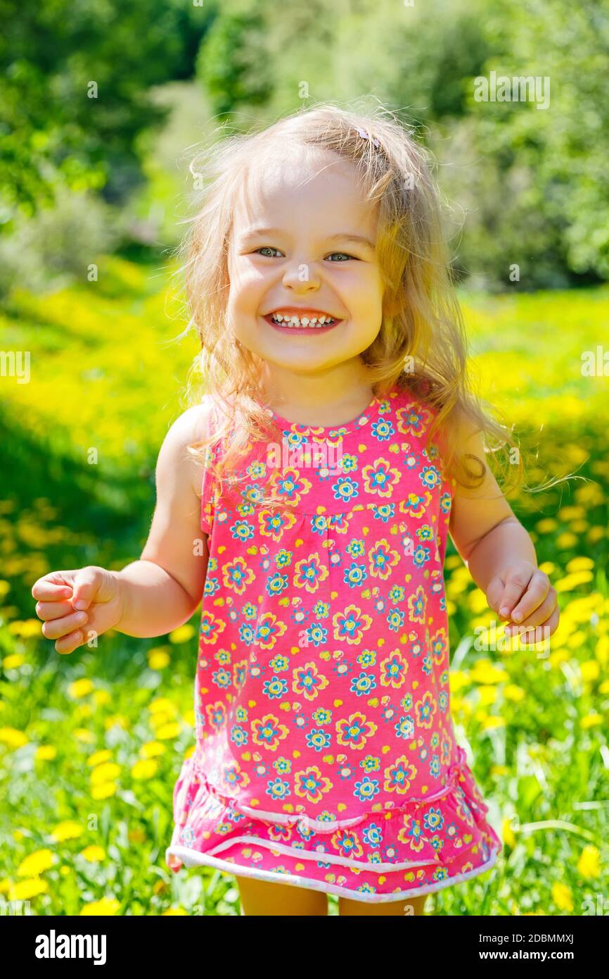 Happy little girl playing in the park Stock Photo - Alamy