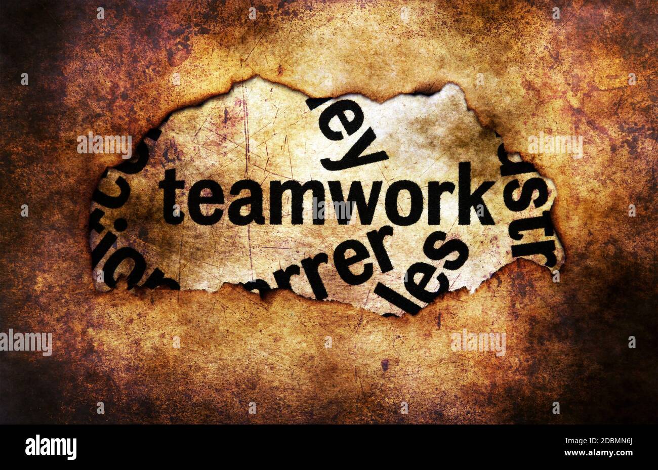Teamwork text on paper hole grunge concept Stock Photo - Alamy