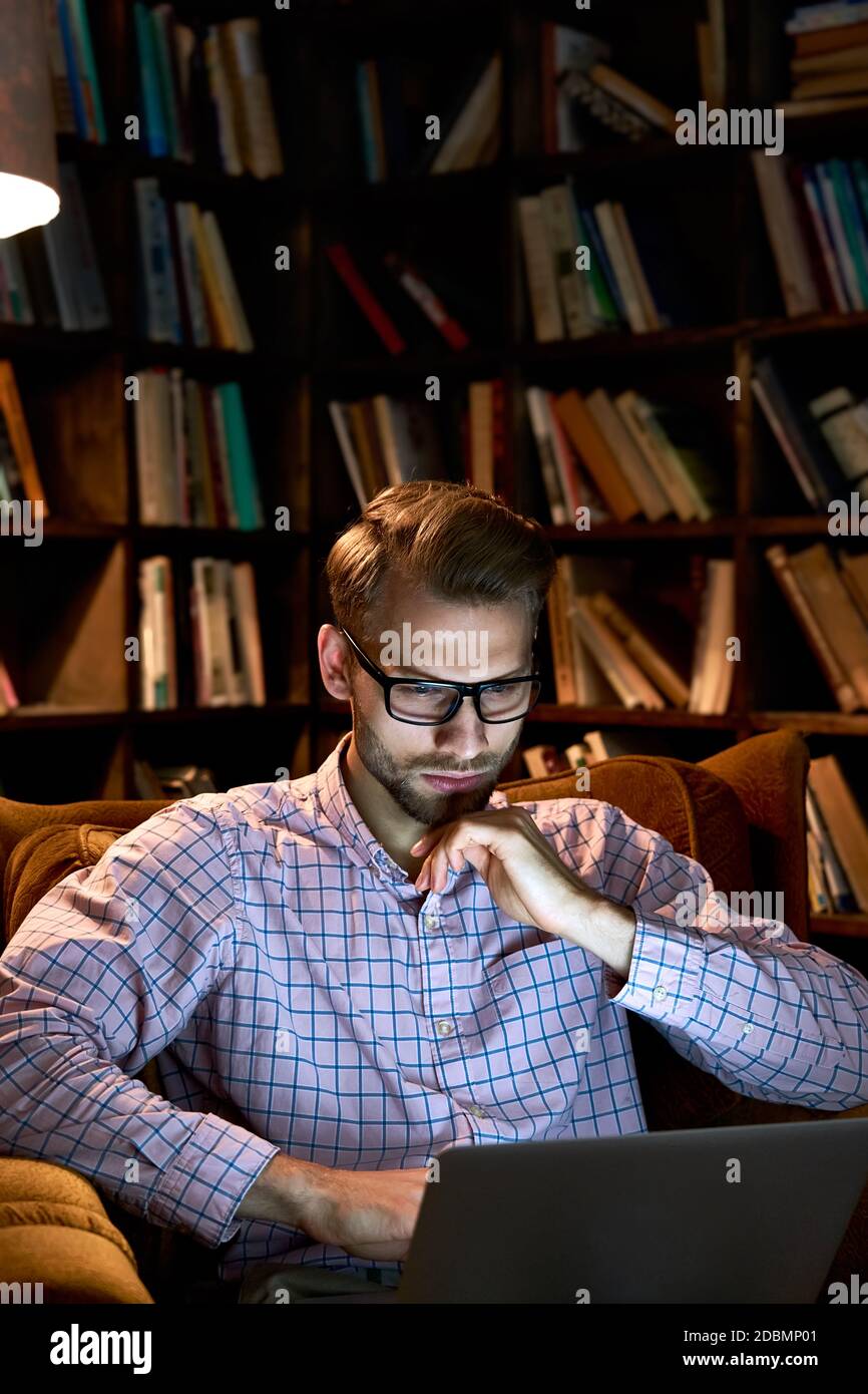 Serious young man using computer at hi-res stock photography and images ...