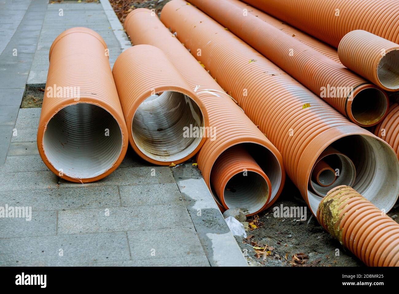Plastic PVC pipes stacked in rows at construction site on ...