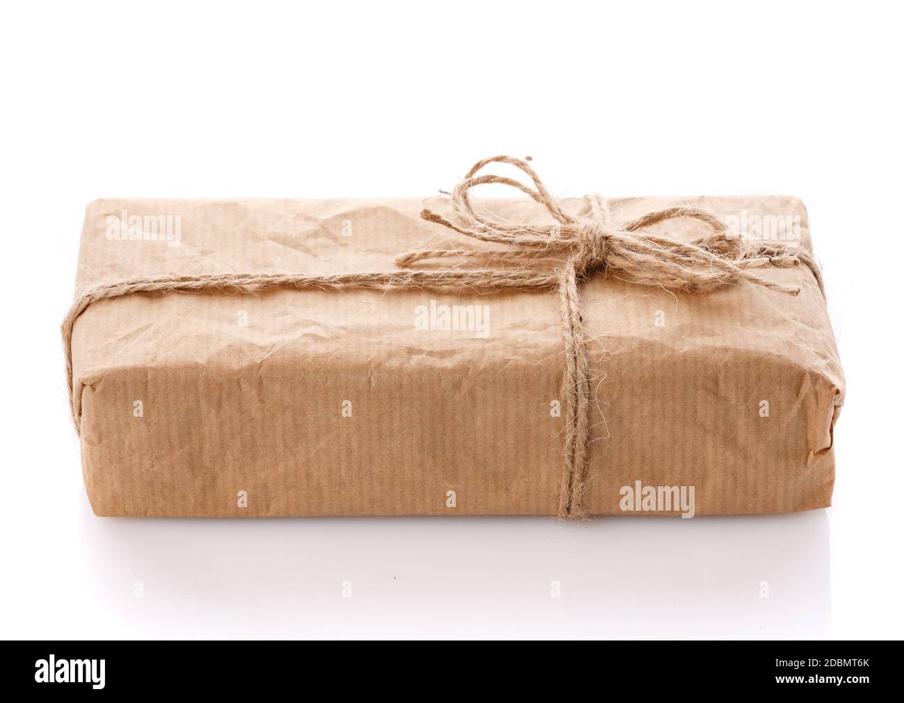 Parcel wrapped in brown kraft paper isolated on white background. Side ...