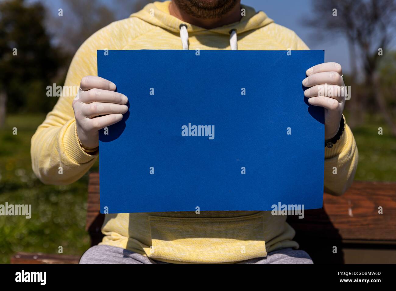 Blue chroma key paper held by a man in surgical gloves Stock Photo - Alamy