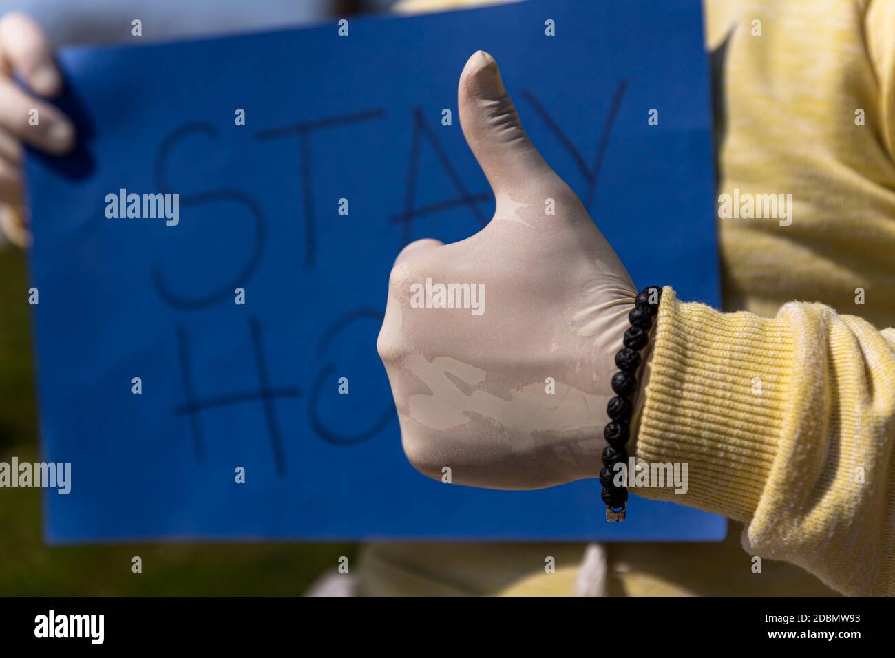 Stay home sign on blue chroma key paper held by a man in surgical ...