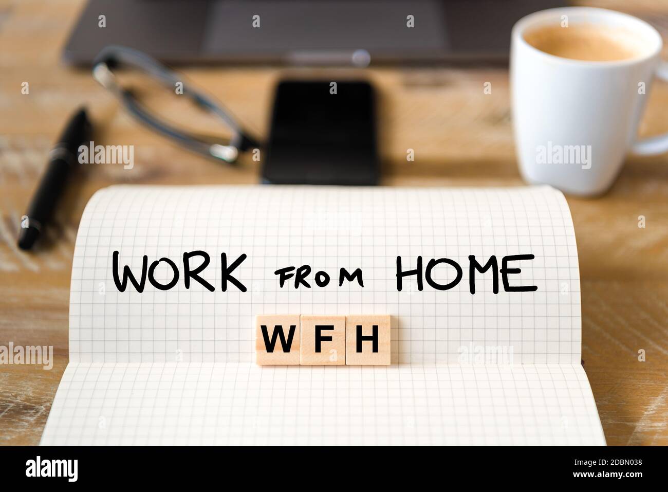 Closeup on notebook over wood table background, focus on wooden blocks ...