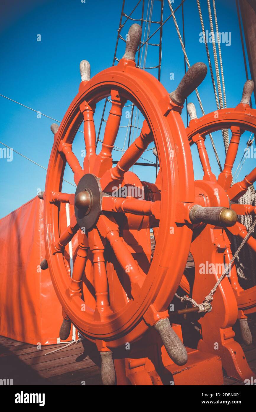 Red wooden wheel helm on antique ship Stock Photo - Alamy