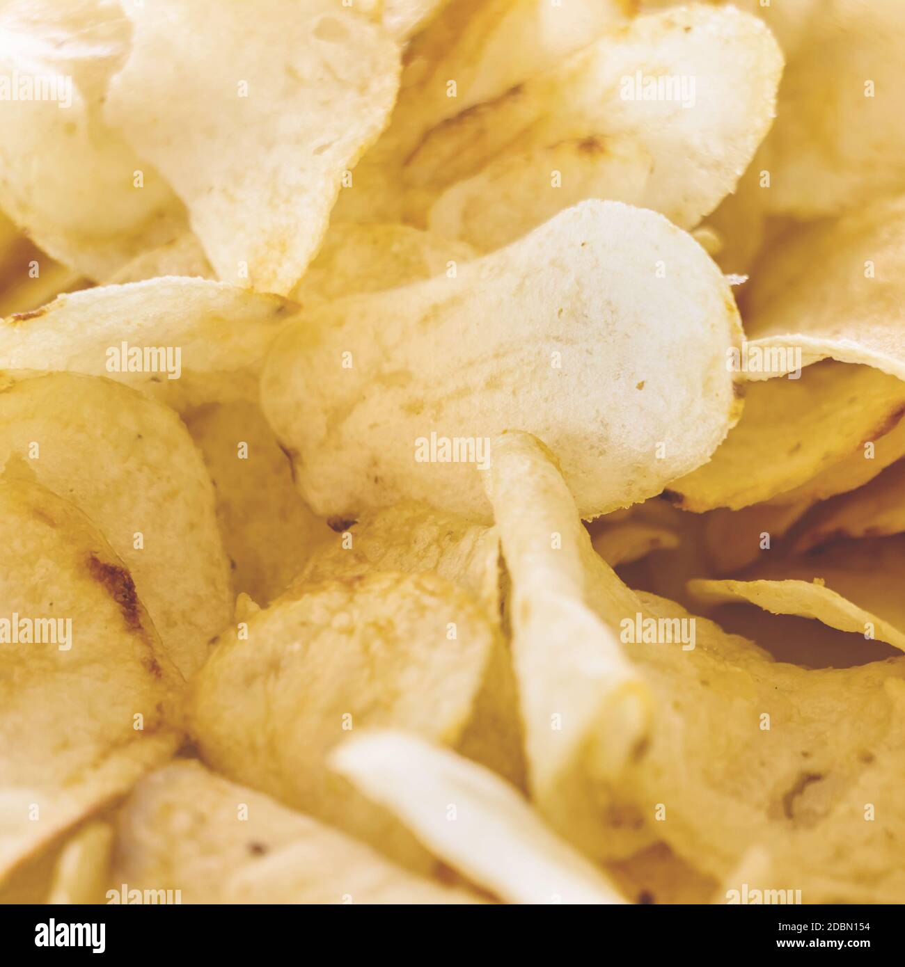 Yellow salted potato chips as background. Crispy chips golden pattern ...