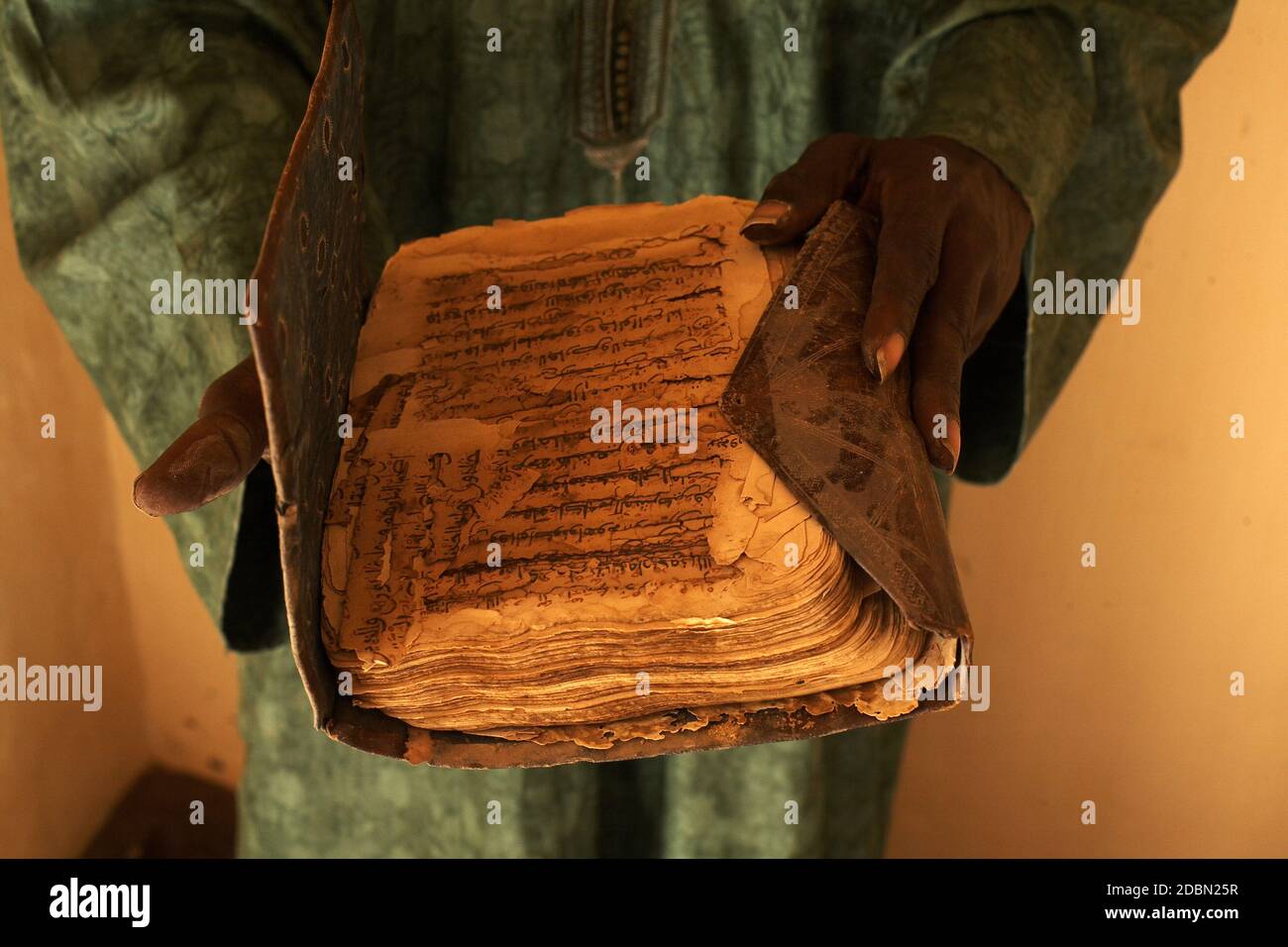 Hands holding manuscripts at the private Al-Wangari Library, in ...