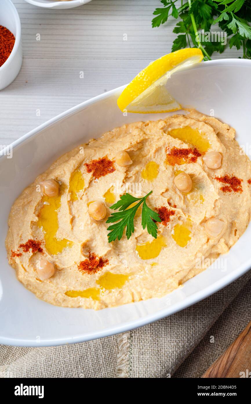 hummus paste with lemon and chilli on white background Stock Photo - Alamy