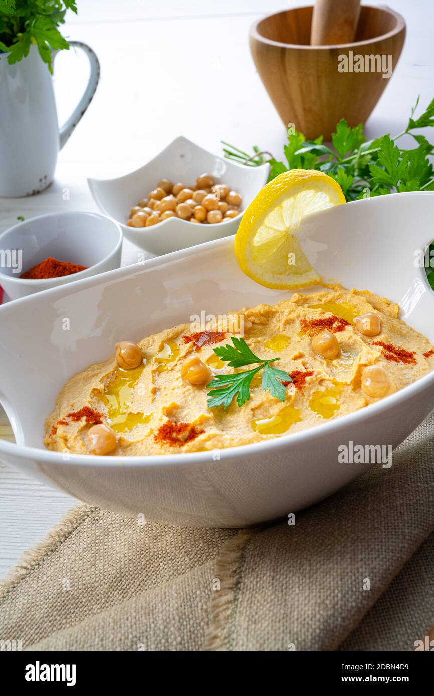 hummus paste with lemon and chilli on white background Stock Photo - Alamy